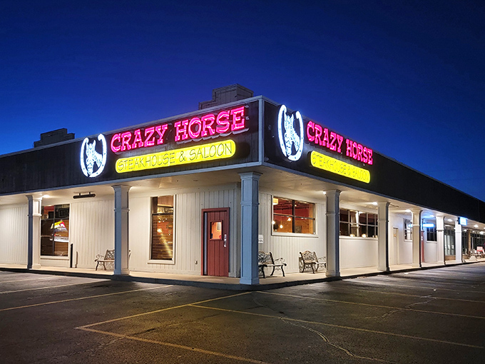 The unassuming exterior of Crazy Horse Steak House hides a carnivore's paradise within. Like finding a treasure map in your attic, this sign points to delicious adventures.