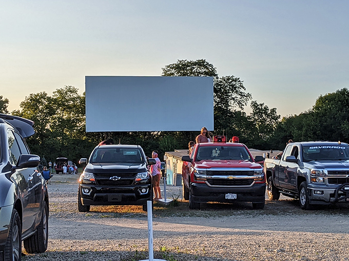 Twilight transforms this gravel lot into a communal living room, where strangers become neighbors under the glow of cinema magic. 