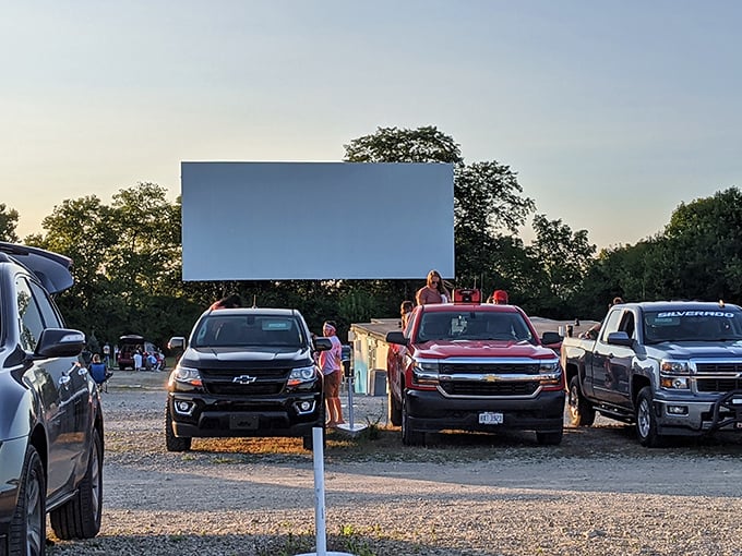 Twilight transforms this gravel lot into a communal living room, where strangers become neighbors under the glow of cinema magic. 