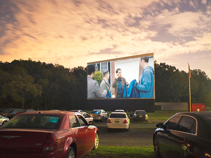 Twilight magic unfolds as cars gather beneath a Pennsylvania sky, the massive screen glowing with cinematic promise. Modern technology meets nostalgic tradition.