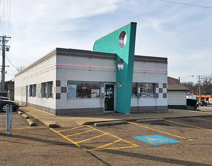 That iconic turquoise fin jutting skyward isn't just architectural flair&mdash;it's a beacon calling hungry travelers to a genuine slice of Americana in Alliance.