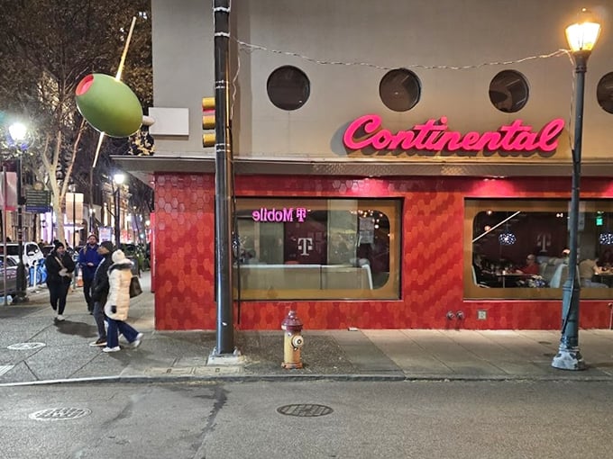 The Continental's iconic red fa&ccedil;ade with porthole windows stands like a retro spaceship that landed in Rittenhouse Square, promising culinary adventures within.