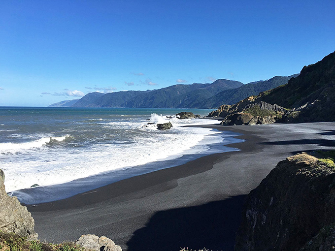 Nature's color inversion at its finest&mdash;dramatic black sand meets frothy white waves along California's most otherworldly shoreline.