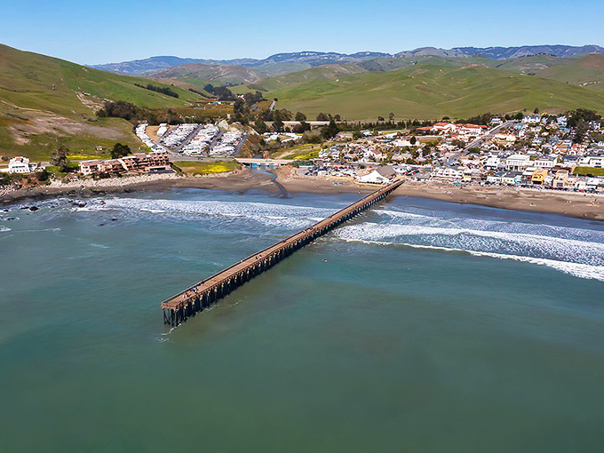 The iconic Cayucos pier stretches into the Pacific like a wooden welcome mat, connecting the quaint town to the endless blue horizon.