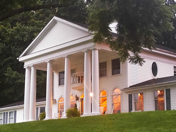 The grand white columns and sweeping lawn make this Georgian Manor look like it was plucked straight from a period drama. Mr. Darcy might appear at any moment.