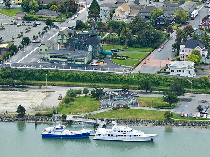 Eureka's Victorian splendor meets maritime charm in this postcard-perfect view. The Carson Mansion's turrets stand sentinel over Humboldt Bay's working harbor.