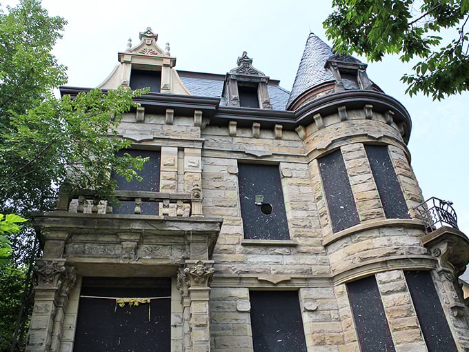 The stone facade of Franklin Castle stands defiantly against time, its turrets and bay windows practically daring you to knock on that crimson door.