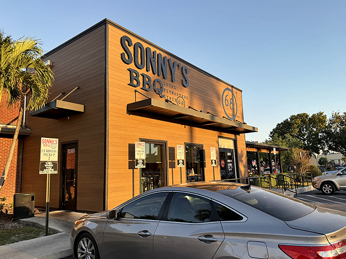 The wooden fa&ccedil;ade of Sonny's BBQ in Homestead stands like a beacon to hungry travelers, promising smoky delights within those unassuming walls.