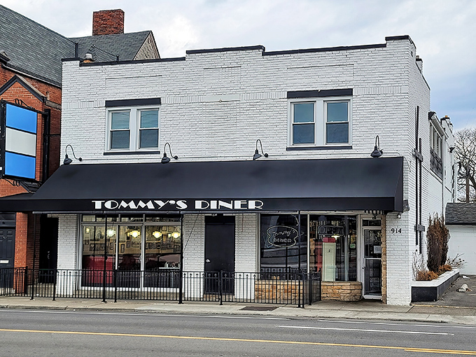 The classic white brick exterior of Tommy's Diner stands proudly on West Broad Street, its black awning like a welcome sign for breakfast enthusiasts.