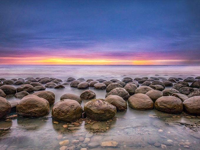Nature's bowling alley at sunset. The Pacific's golden light transforms these ancient spherical rocks into a scene straight from a sci-fi masterpiece.