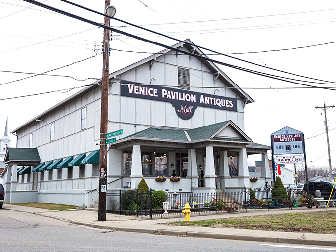 The stately white facade of Venice Pavilion Antiques welcomes treasure hunters with its Civil War-era cannon display and inviting front porch.