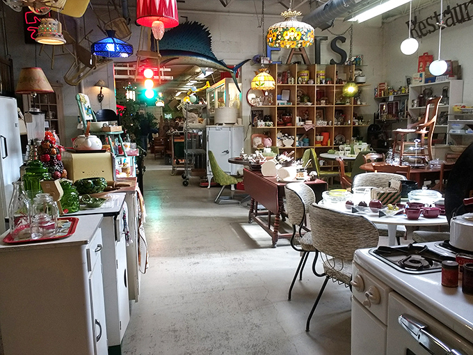 Step into this time-traveling treasure trove where vintage kitchen appliances mingle with mid-century furniture under the watchful gaze of a traffic light that never turns red.