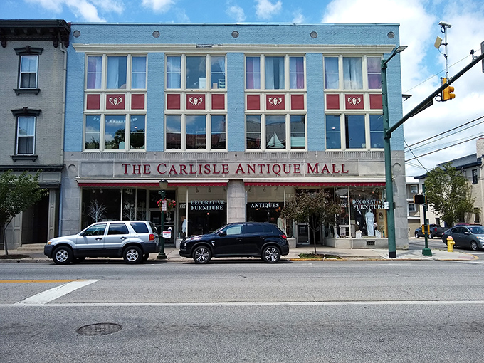 The iconic blue facade of The Carlisle Antique Mall stands proudly on Hanover Street, a beacon for treasure hunters in Pennsylvania's Cumberland Valley.