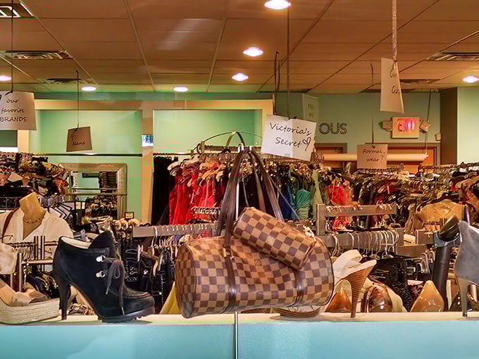 A rainbow of formal wear awaits, each gown protected like a celebrity before the red carpet. Fashion dreams in plastic cocoons.