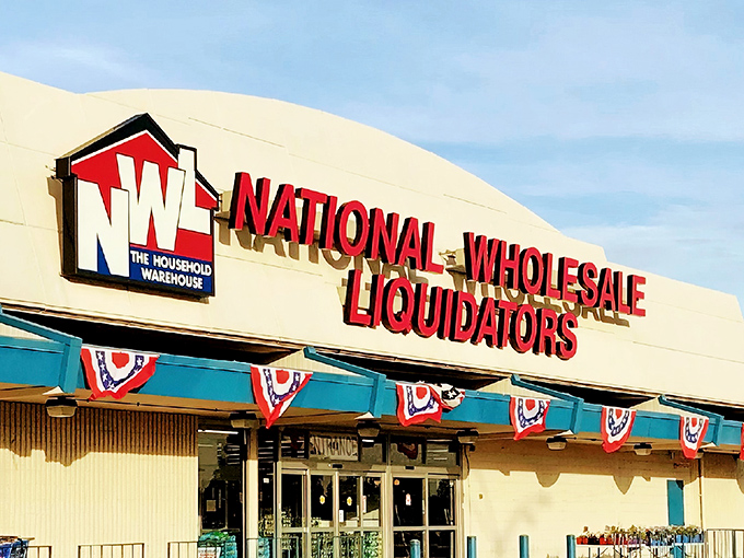 The iconic red signage of National Wholesale Liquidators beckons bargain hunters like a retail lighthouse guiding ships to discount shores.