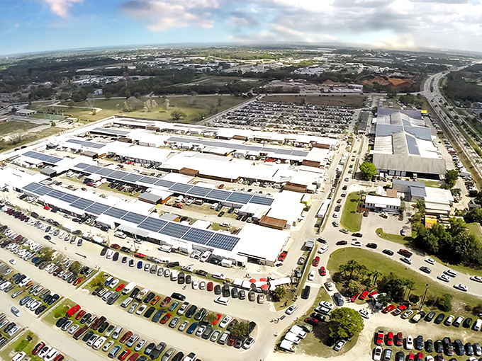 From above, the sprawling Fleamasters Flea Market stretches across the landscape, a maze of vendor stalls framed by Florida palm trees &mdash; a true bargain hunter&rsquo;s paradise seen from the sky.
