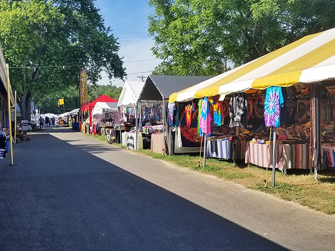 Treasure hunting under blue Indiana skies! The outdoor vendor area transforms into a bustling marketplace where one person's forgotten flag collection becomes another's prized decor.