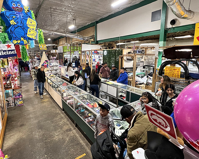 Glass display cases become treasure chests at Durham Green Flea Market, where shoppers hunt for collectibles while colorful pi&ntilde;atas stand guard overhead.