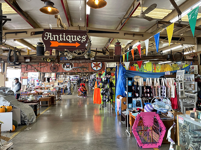 Colorful pennants and vintage treasures line this corridor of discovery, where "just browsing" becomes a three-hour adventure through organized chaos.