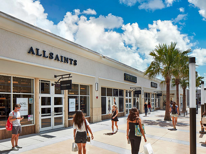 The iconic Vineland sign welcomes shoppers like a retail Statue of Liberty, promising freedom from full retail prices under Florida's endless blue skies.