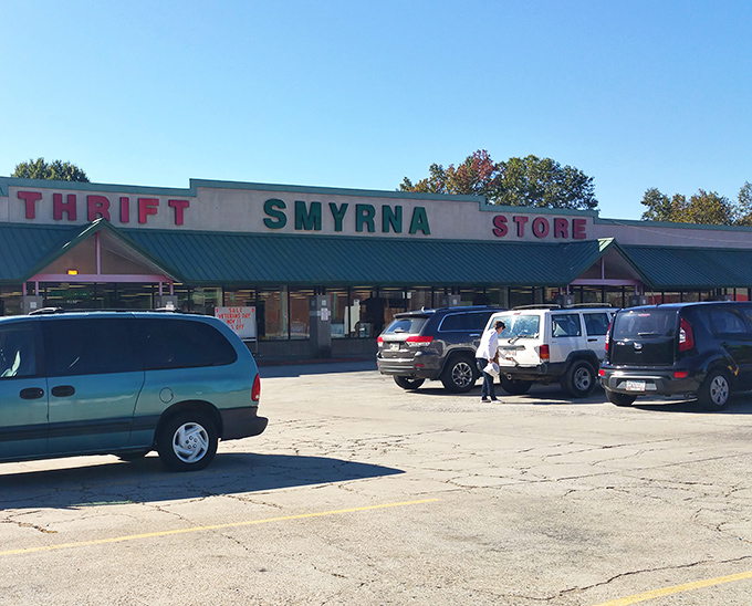 The iconic green-roofed Smyrna Thrift Store stands like a treasure chest waiting to be opened, its bold red and green signage promising adventures in secondhand shopping.