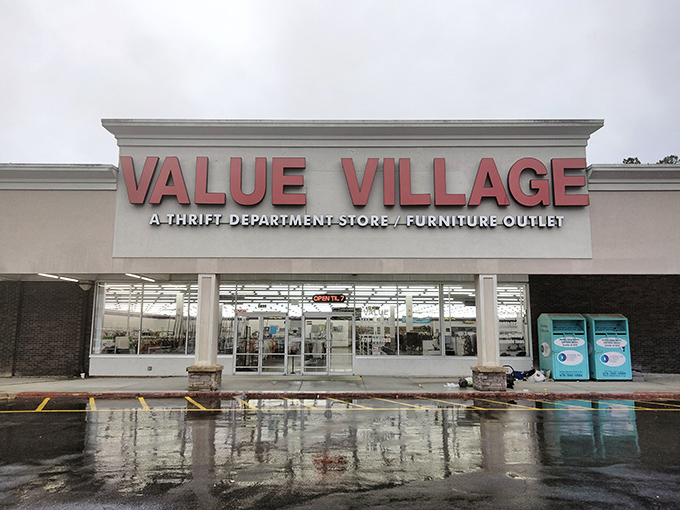 The neon-red Value Village sign glows like a beacon for bargain hunters, promising treasures within its walls as dusk settles over Decatur. 