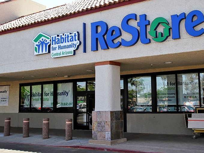 The desert sun gleams off the ReStore's distinctive blue and green signage, promising treasure hunters a climate-controlled oasis of bargains inside.