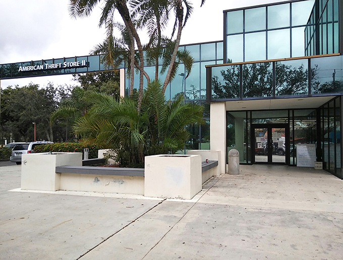 The sleek, modern exterior of American Thrift Store belies the treasure trove within. Palm trees stand guard like sentinels of savings.