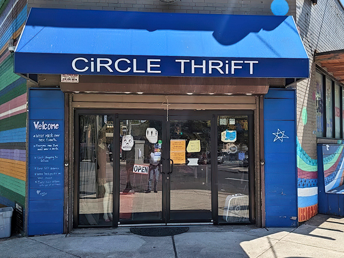 The blue awning beckons like a portal to bargain paradise. Circle Thrift's vibrant storefront stands out in Philadelphia's urban landscape, promising treasures within.
