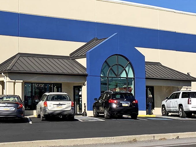 The blue-trimmed exterior of Re-Uzit Shop stands like a temple to thrift, promising treasures inside that'll make your wallet sing with joy.