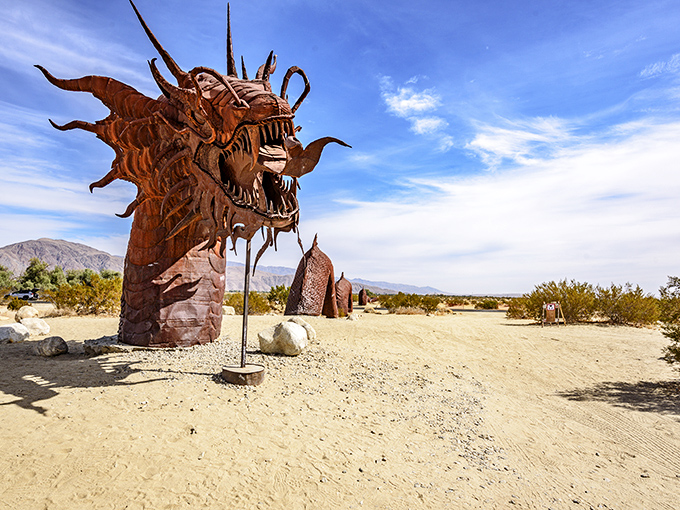 Desert showdown! A massive metal scorpion faces off against an ant in this surreal landscape where prehistoric creatures rule the sand.
