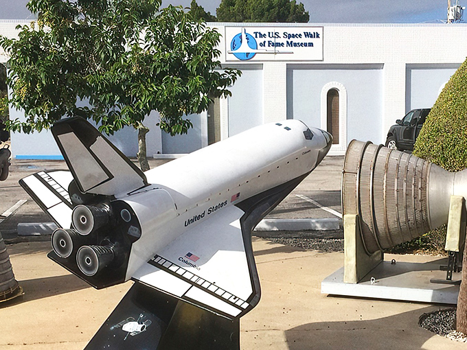 The ultimate Florida welcome committee: a space shuttle model and rocket engine greeting visitors outside the museum. Space exploration's version of a garden gnome!