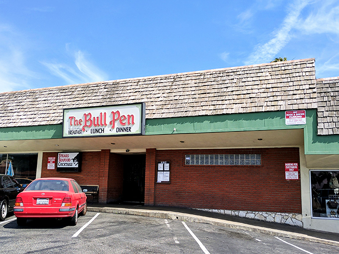 The unassuming exterior of The Bull Pen hides a culinary time capsule. Those weathered shingles have sheltered decades of memorable meals and celebrations.