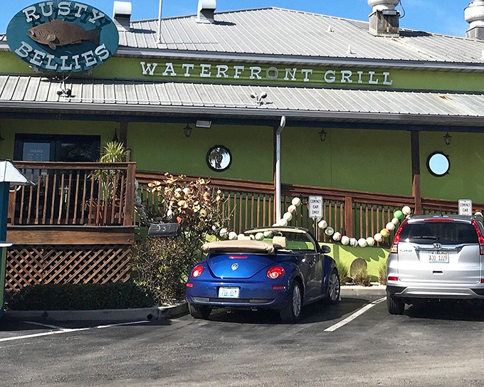 The vibrant lime-green exterior of Rusty Bellies stands out like a tropical oasis, promising seafood treasures within its cheerful walls.