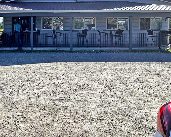 The American flag waves proudly outside 73 Grill, where the blue Pepsi banner announces Taco Tuesday like it's the social event of the week. 