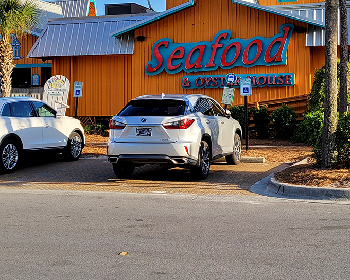 The Back Porch's rustic wooden exterior and bright red "Seafood" sign stand as a beacon for hungry beachgoers seeking Gulf treasures.