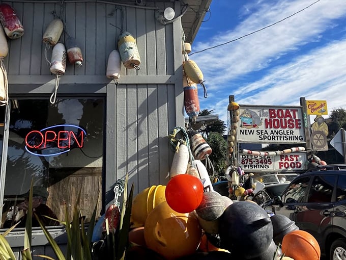 Maritime charm at its finest! The Boat House's weathered exterior adorned with colorful buoys isn't designer-crafted coastal—it's the real seafaring deal.
