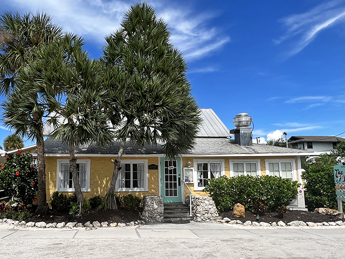 The little yellow cottage with the turquoise door isn't trying to impress anyone—until you taste what's cooking inside. Florida charm personified.