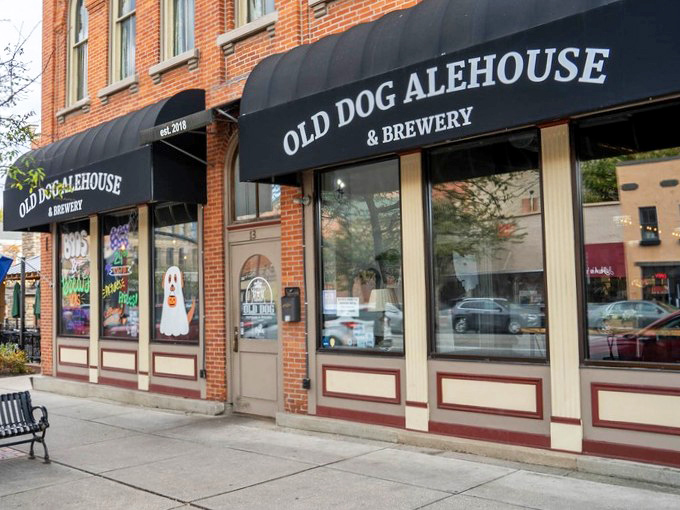 The classic brick façade of Old Dog Alehouse & Brewery beckons like an old friend with a new secret to share. Those black awnings aren't just stylish—they're practically winking at you.
