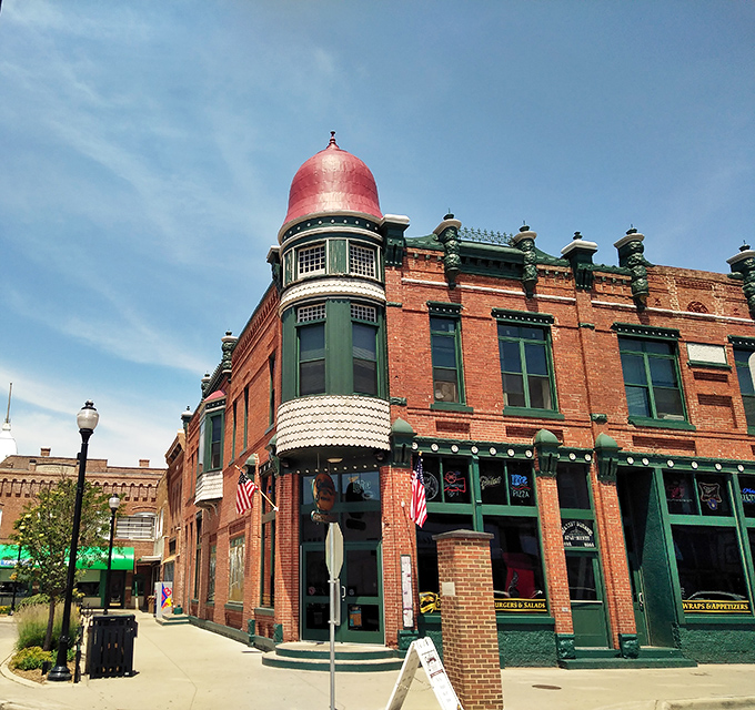 The historic brick building with its distinctive copper dome stands proudly on the corner, like a Victorian gentleman who secretly makes the best barbecue in town.