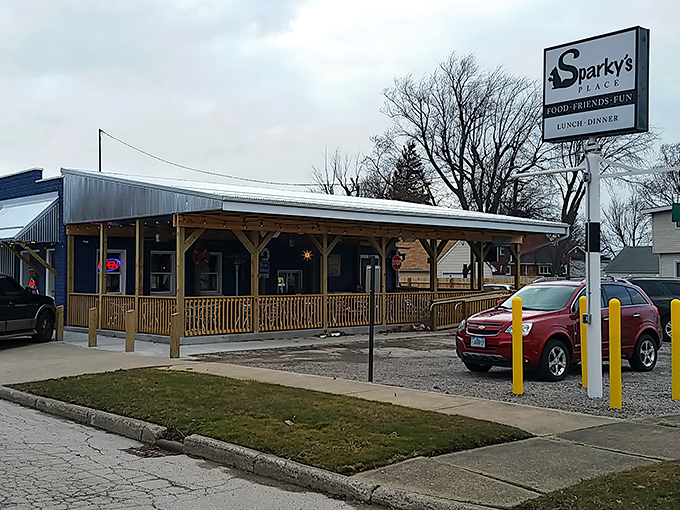 The bright blue exterior of Sparky's Place stands out like a beacon of culinary hope on Conneaut's streetscape, hanging baskets adding a touch of homey charm.