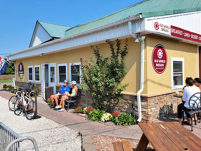 This charming yellow building with its green roof practically whispers "homemade goodness" from every weathered board.