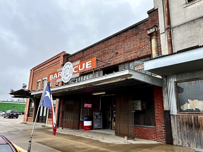 The brick fa&ccedil;ade and iconic red sign of Louie Mueller Barbecue stand as a beacon of hope for hungry travelers. Texas barbecue pilgrimage starts here.