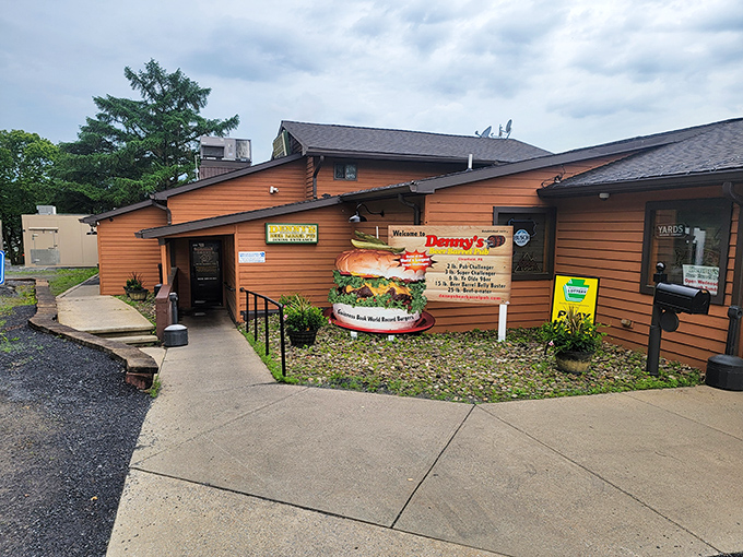 The rustic wooden exterior of Denny's Beer Barrel Pub promises burger adventures that would make Paul Bunyan himself do a double-take.
