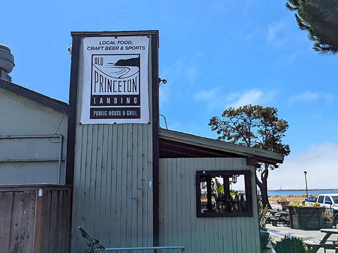 The mint-green exterior beckons like a coastal mirage, promising cold drinks and hot meals after a day of battling Highway 1 traffic.