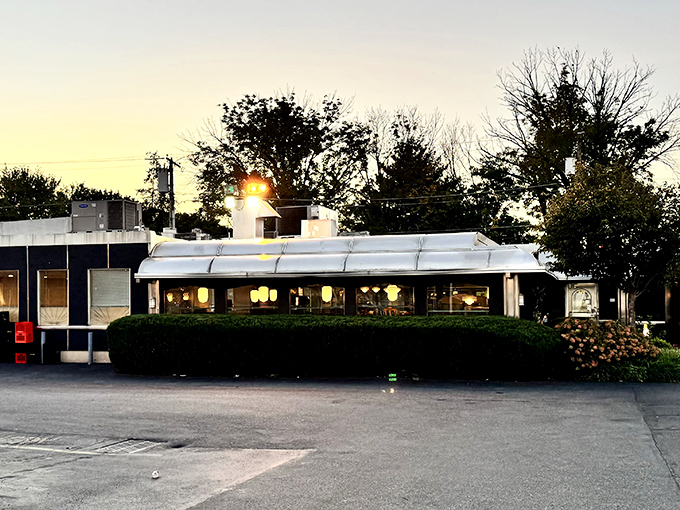 The Dining Car's gleaming silver exterior catches the last light of day, a beacon of hope for hungry travelers and a landmark of Northeast Philly comfort.