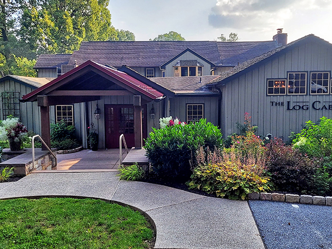 The welcoming entrance to The Log Cabin beckons like an old friend, promising warmth and culinary delights amid Pennsylvania's lush countryside.