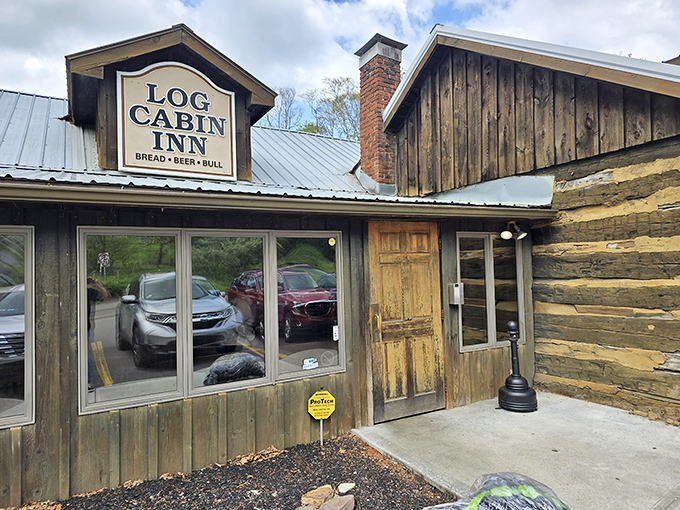 The Log Cabin Inn's weathered wooden exterior isn't just rustic charm&mdash;it's a promise of culinary treasures hiding behind that unassuming frontier facade.
