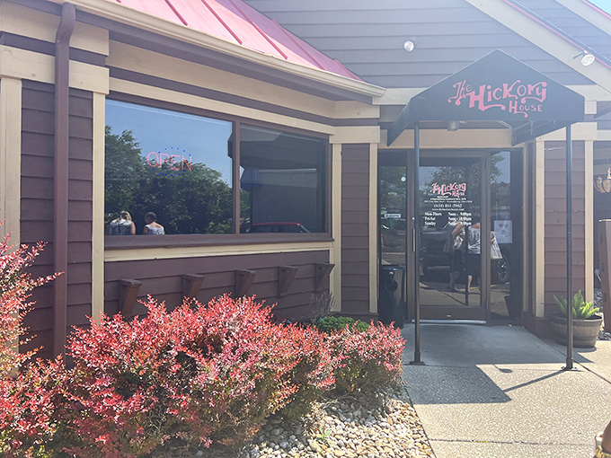 The welcoming exterior of Hickory House beckons with rustic charm, while spring daffodils add a cheerful touch to this barbecue haven.