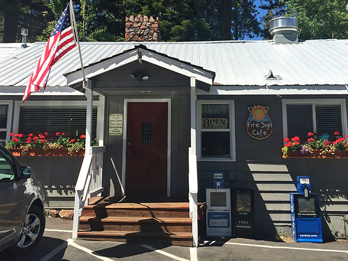 The unassuming exterior of Fire Sign Caf&eacute; stands like a breakfast speakeasy among Tahoe pines, its red door a portal to pancake paradise.